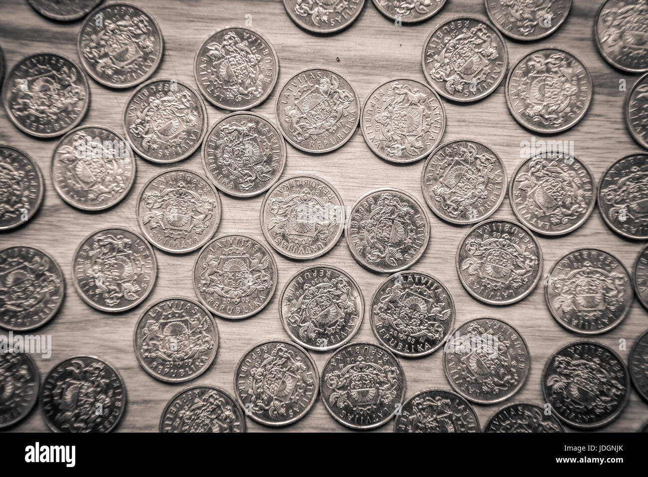 Anniversary lat coins of an old Latvian currency on a wooden background ...