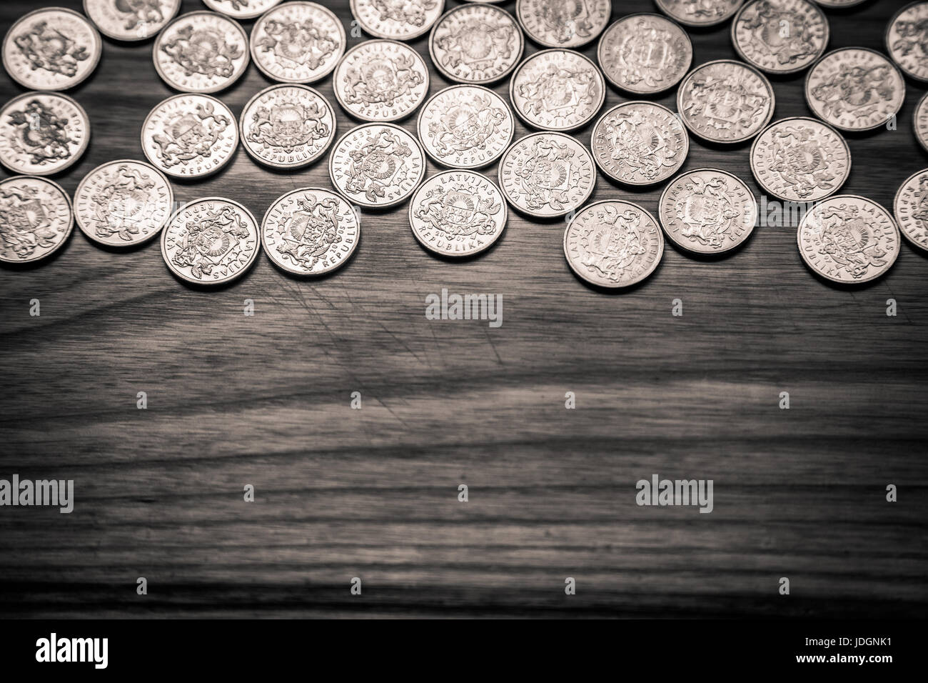 Anniversary lat coins of an old Latvian currency on a wooden background ...