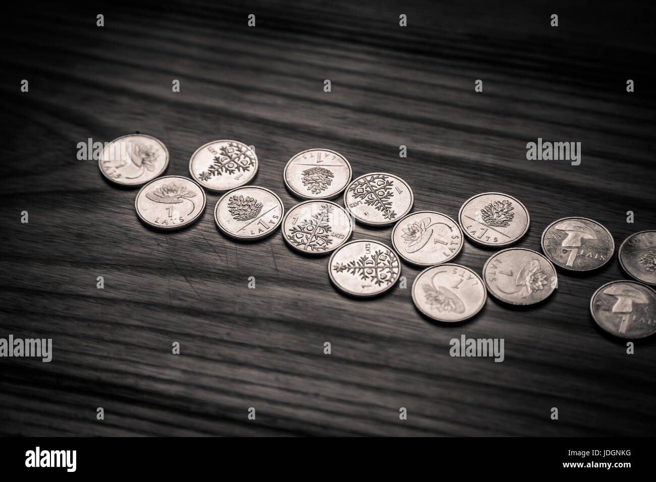 Anniversary lat coins of an old Latvian currency on a wooden background ...