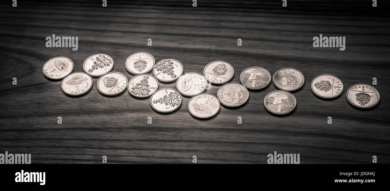 Anniversary lat coins of an old Latvian currency on a wooden background ...
