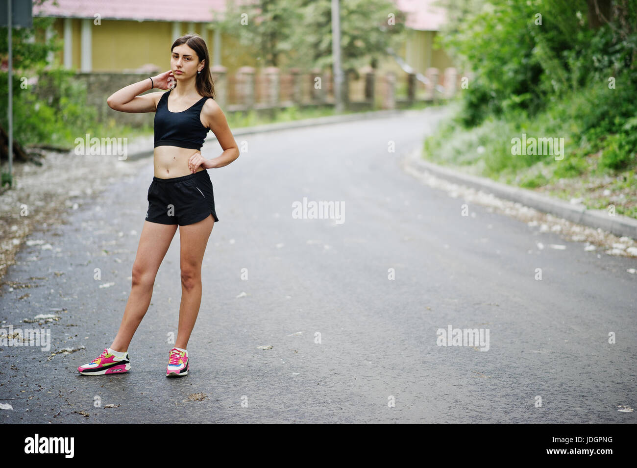 Sport girl at sportswear exercising in a green park and training at ...