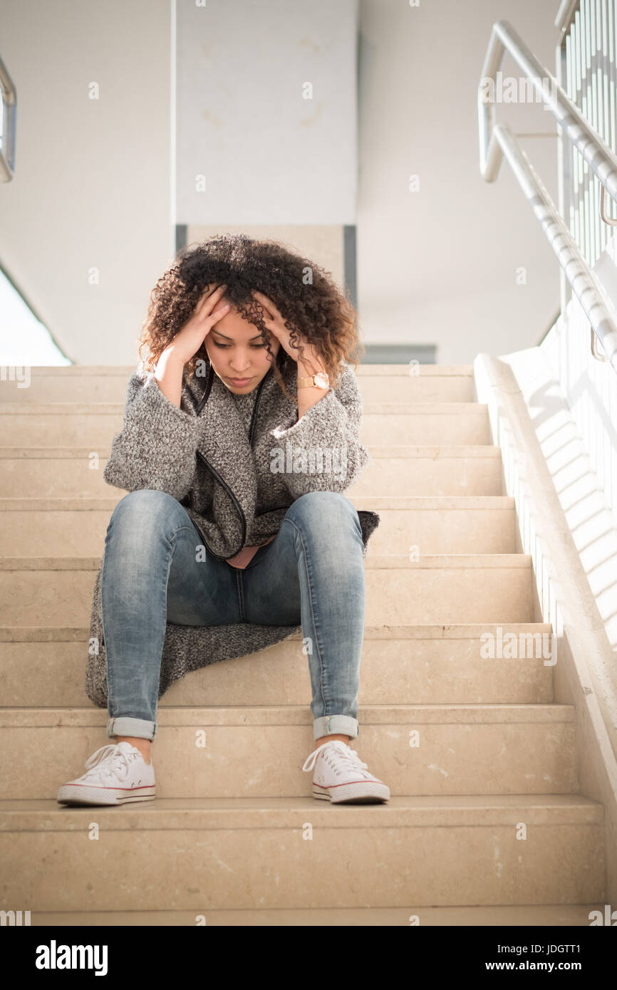 Woman seated on stairs hi-res stock photography and images - Alamy