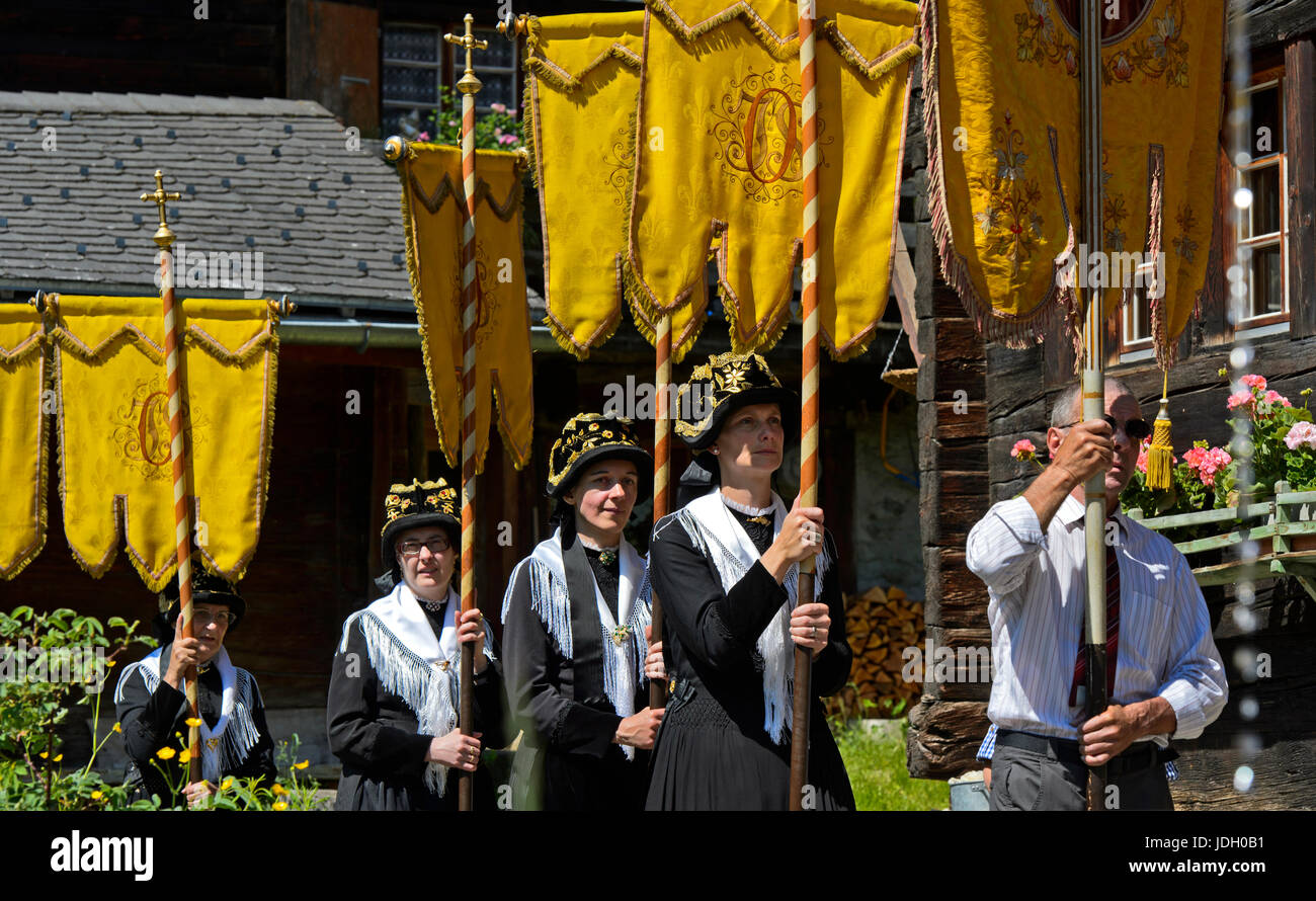 Women in costume carrying religious banners at the Corpus Christi ...