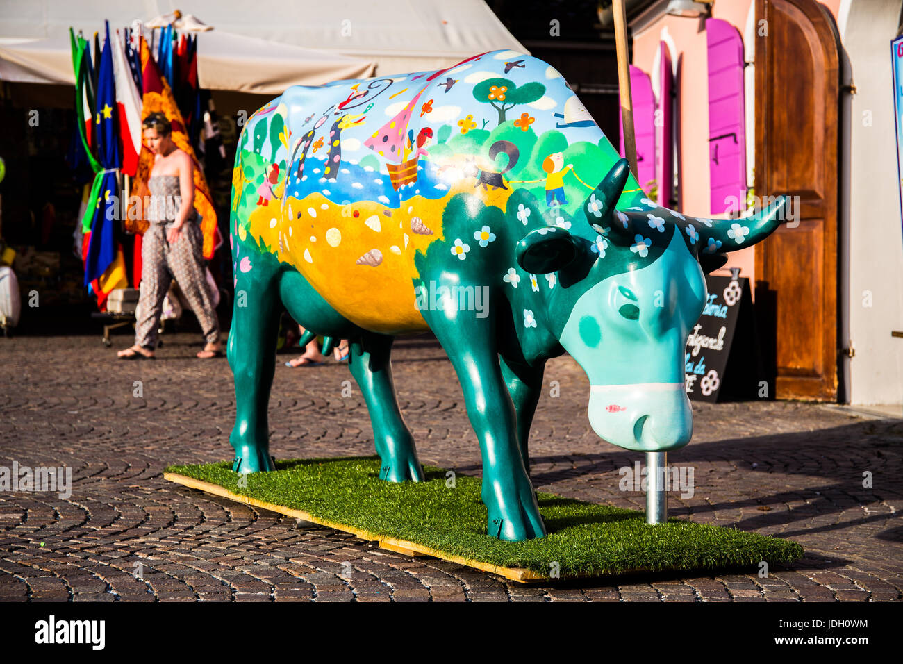 Decorative, human made cow with different colorful drawings in city ...