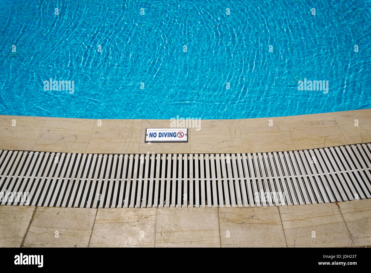 Open air poolside with clear blue water on a sunny day Stock Photo - Alamy