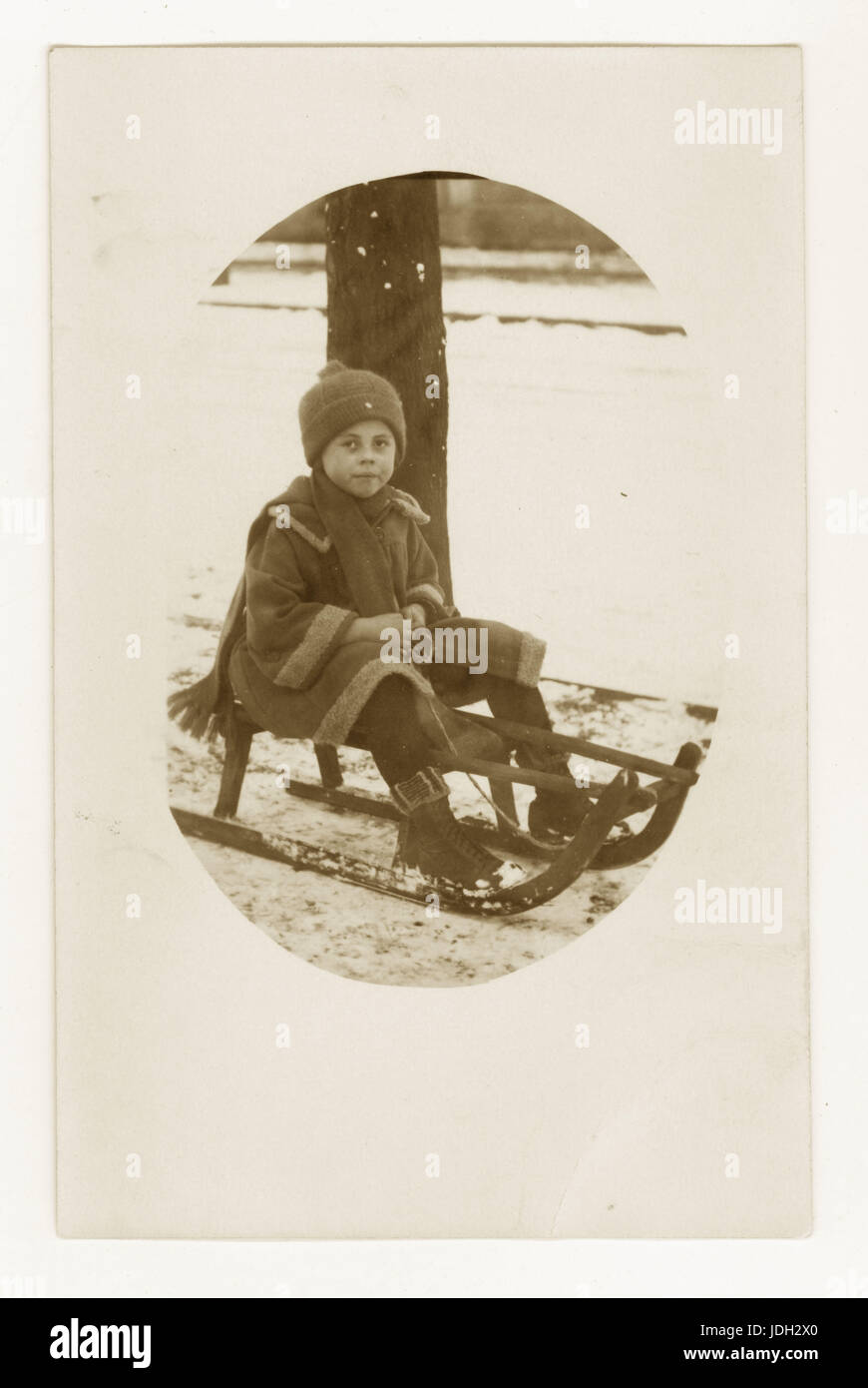 Early 1900's postcard of boy on sledge, possibly German, circa 1930's ...