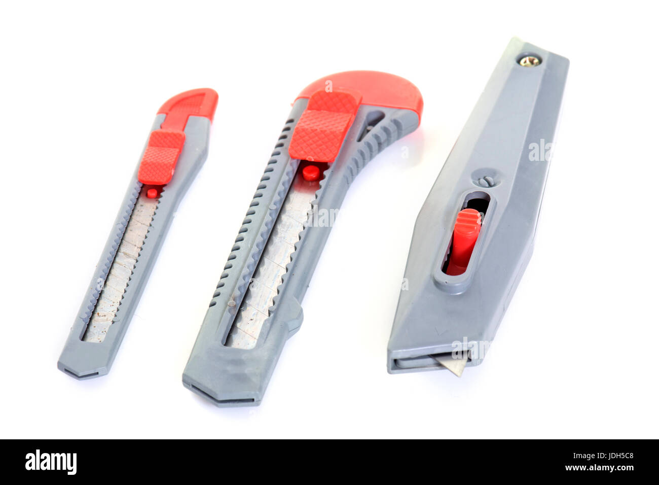 three box cutters in front of white background Stock Photo - Alamy