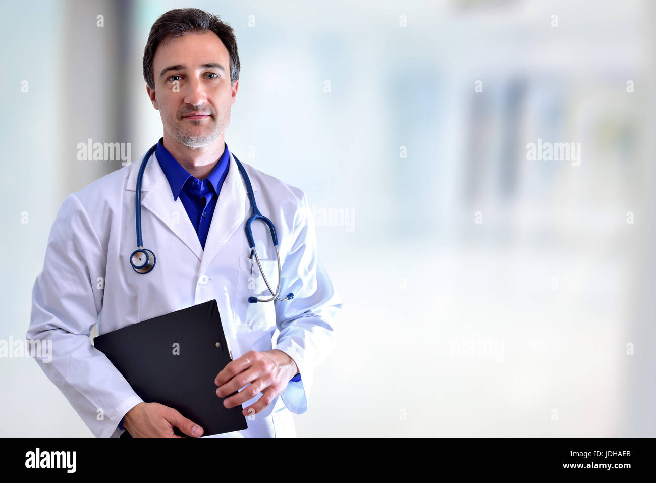 Caucasian general doctor with black clipboard. Front position half body ...