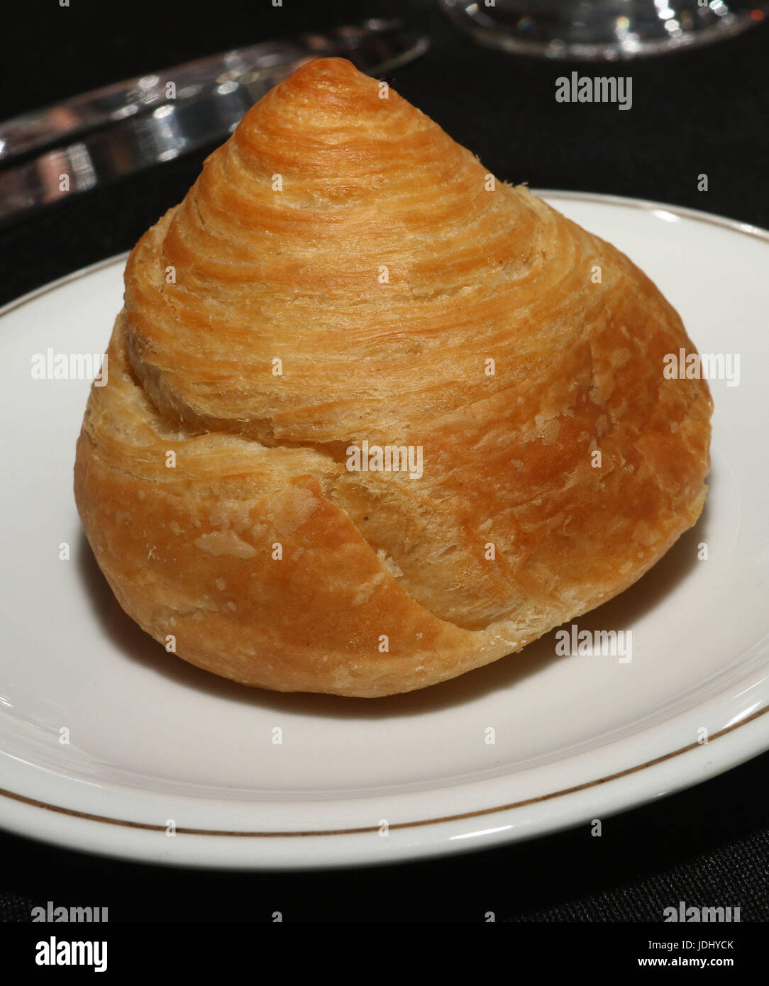 Puffy dinner roll on white plate Stock Photo - Alamy