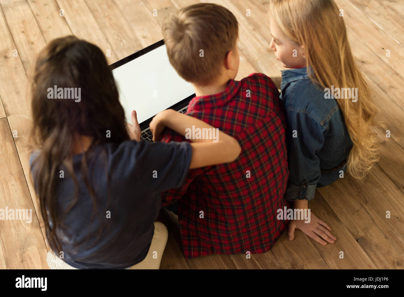 back view of children using digital laptop at home Stock Photo - Alamy
