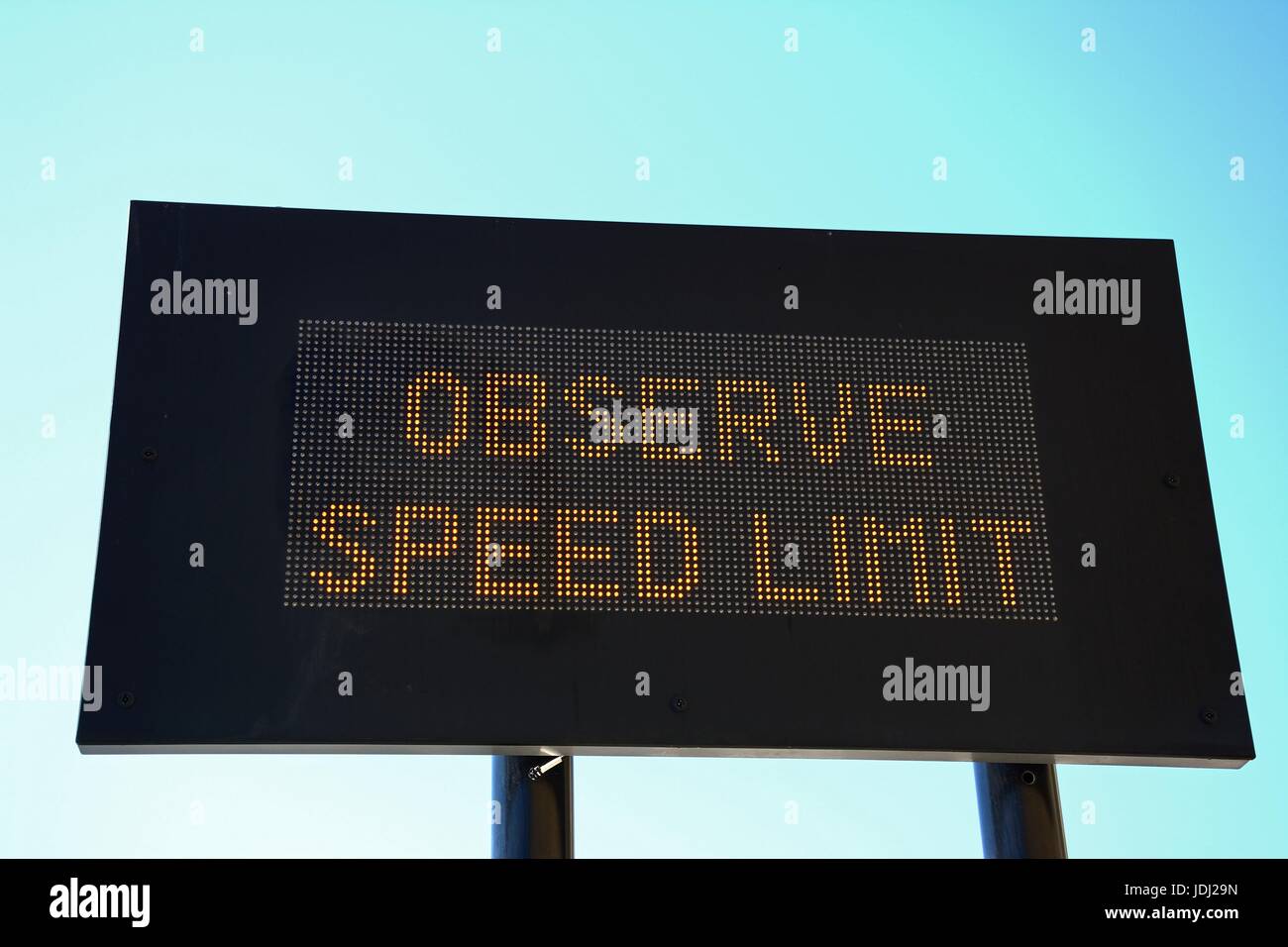 LED Observe speed limit sign with a black border against a blue sky ...