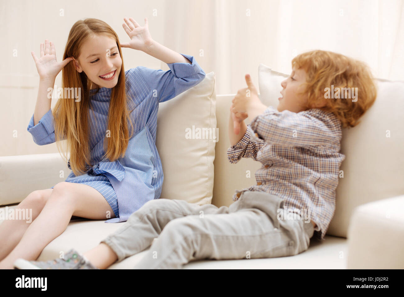 Adorable active siblings teasing each other Stock Photo - Alamy