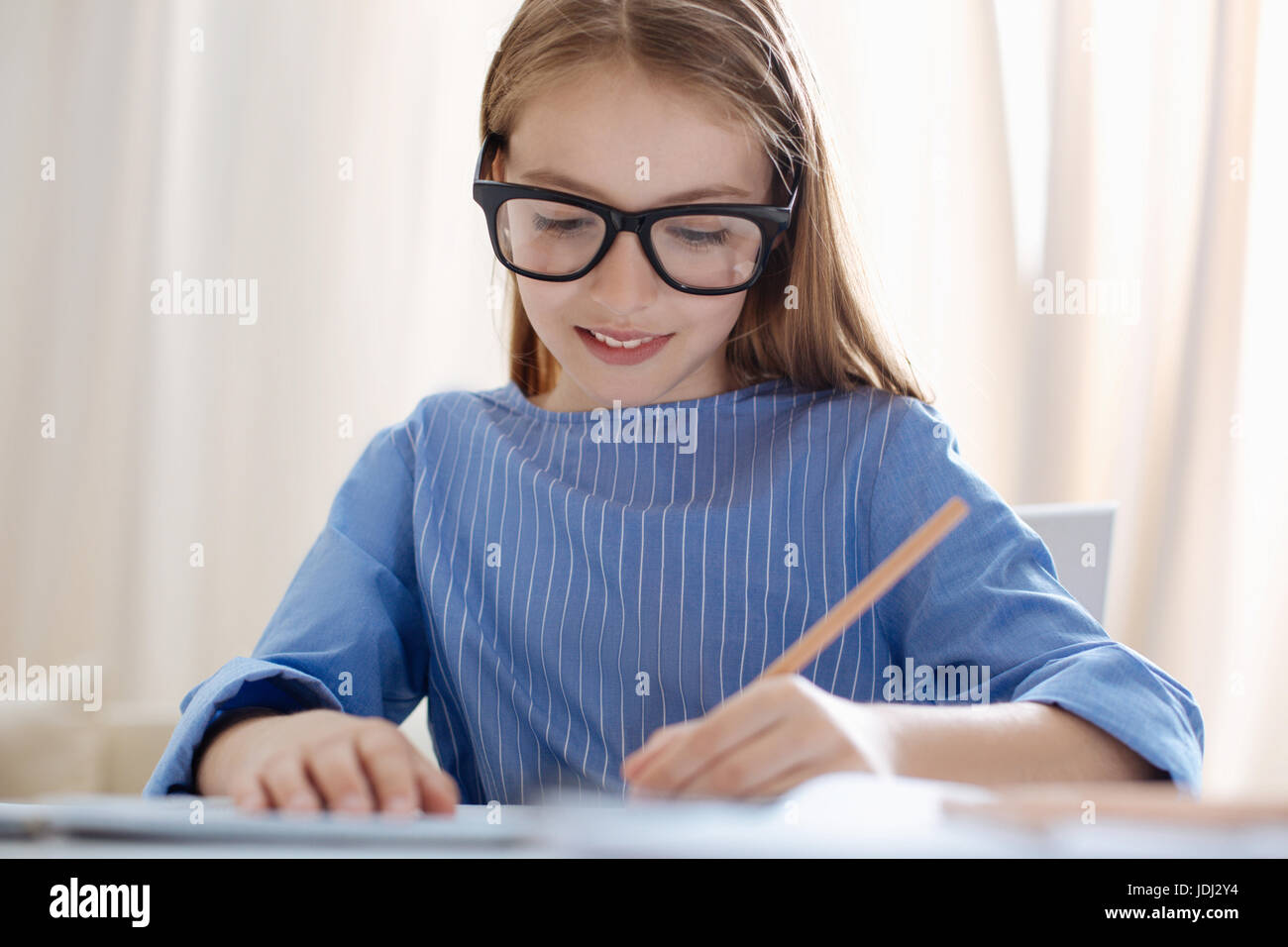Persistent hardworking girl writing something down Stock Photo - Alamy
