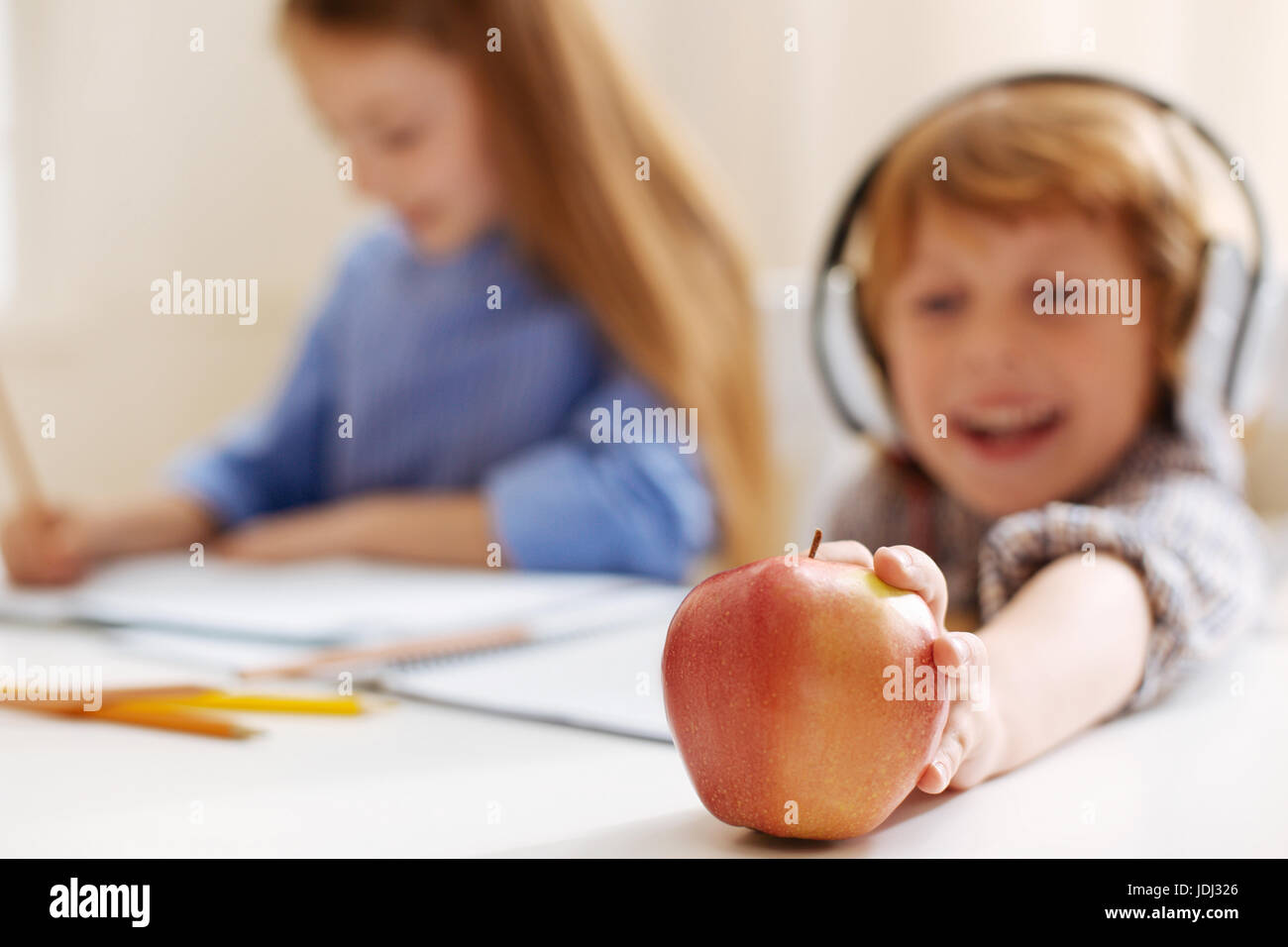 Energetic clever kid taking an apple Stock Photo - Alamy