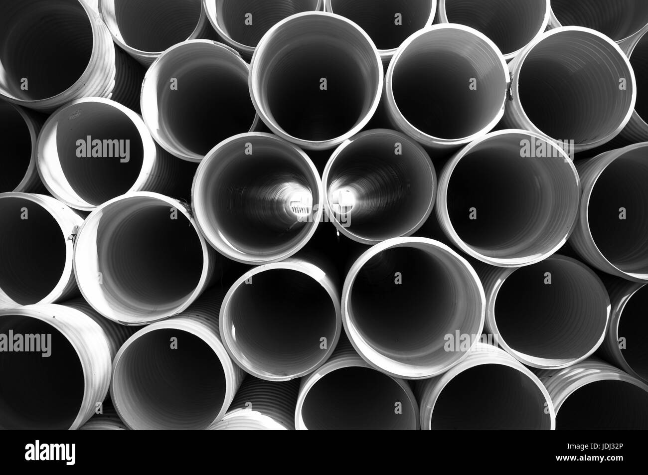 gray PVC tubes plastic pipes stacked in rows pattern Stock Photo - Alamy
