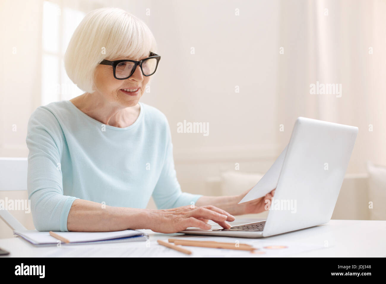 Charismatic intelligent lady writing an email Stock Photo - Alamy