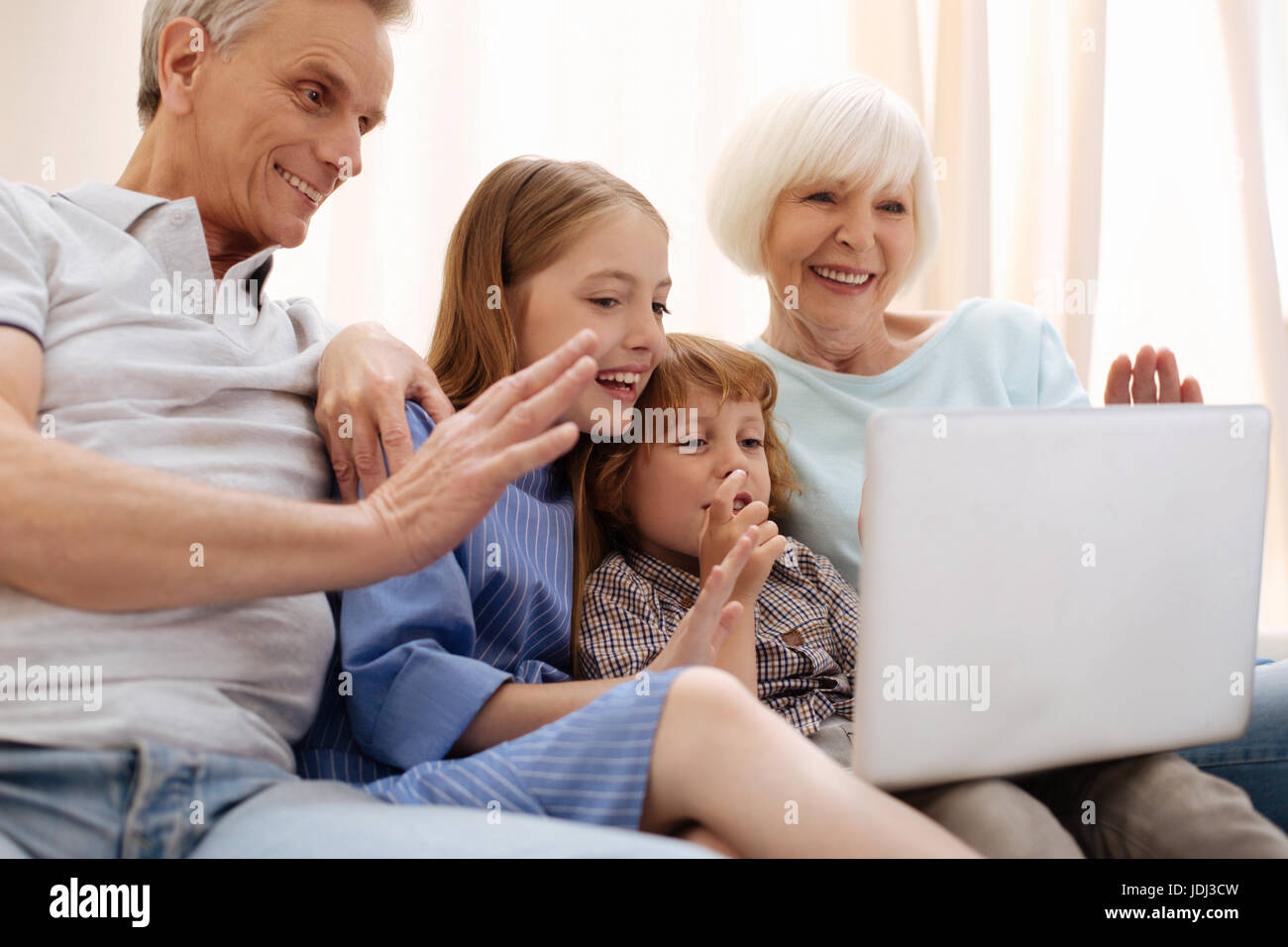 Friendly smart children using laptop for calling parents Stock Photo ...