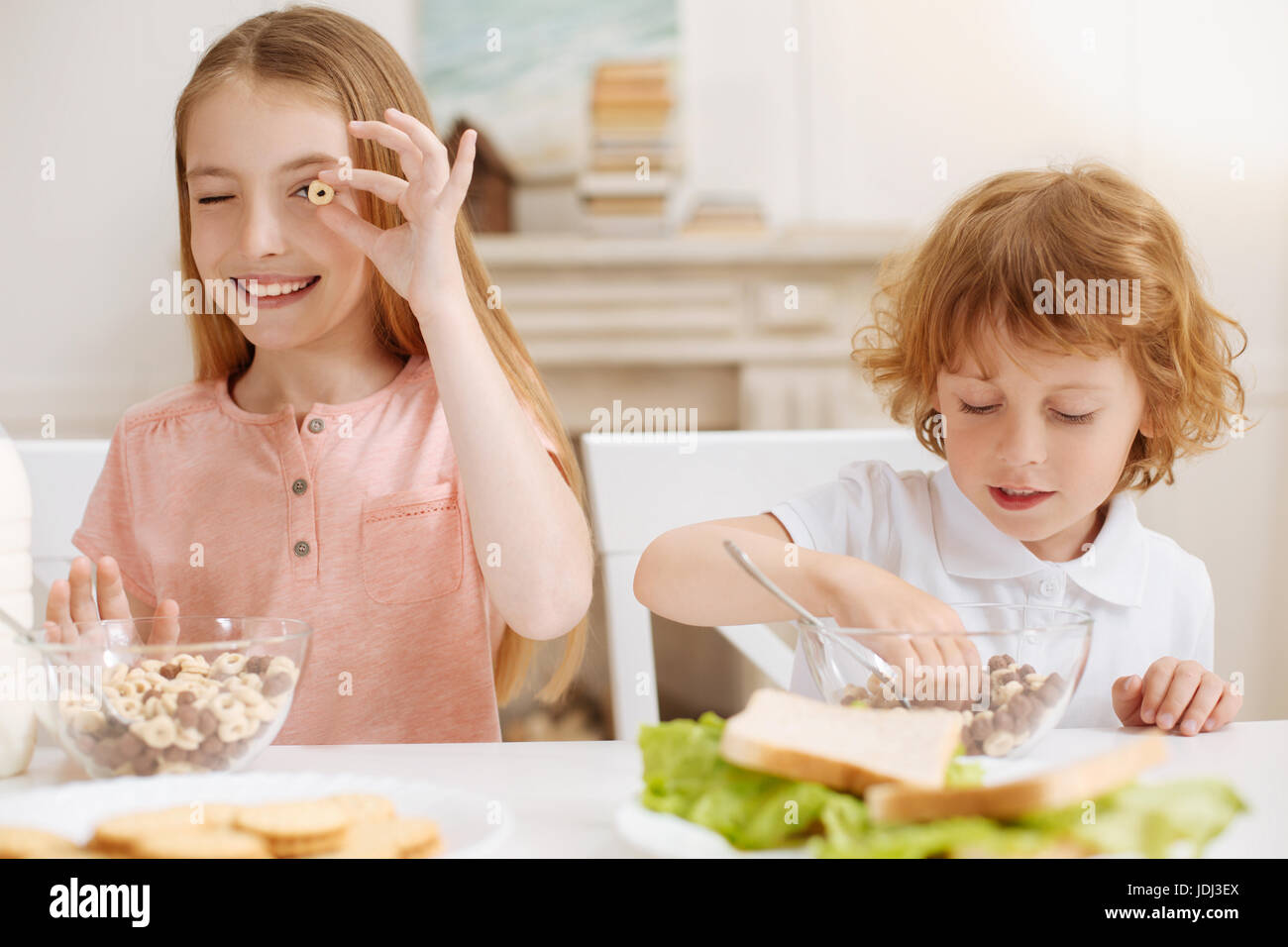 Admirable vibrant siblings having fun with their food Stock Photo - Alamy