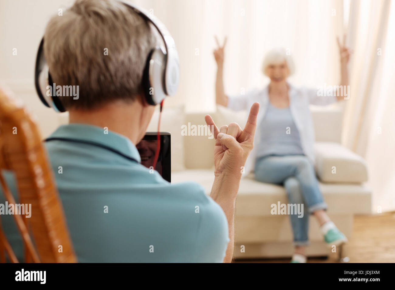 Expressive fun grandpa enjoying some great music Stock Photo - Alamy