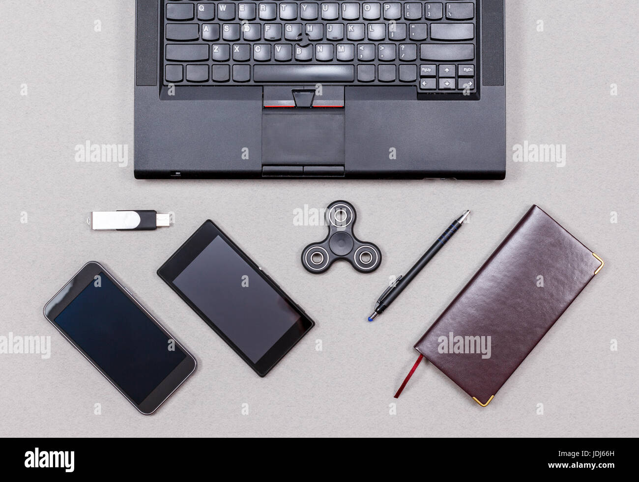 Random office items on table background, notepad, smartphone, pendrive ...