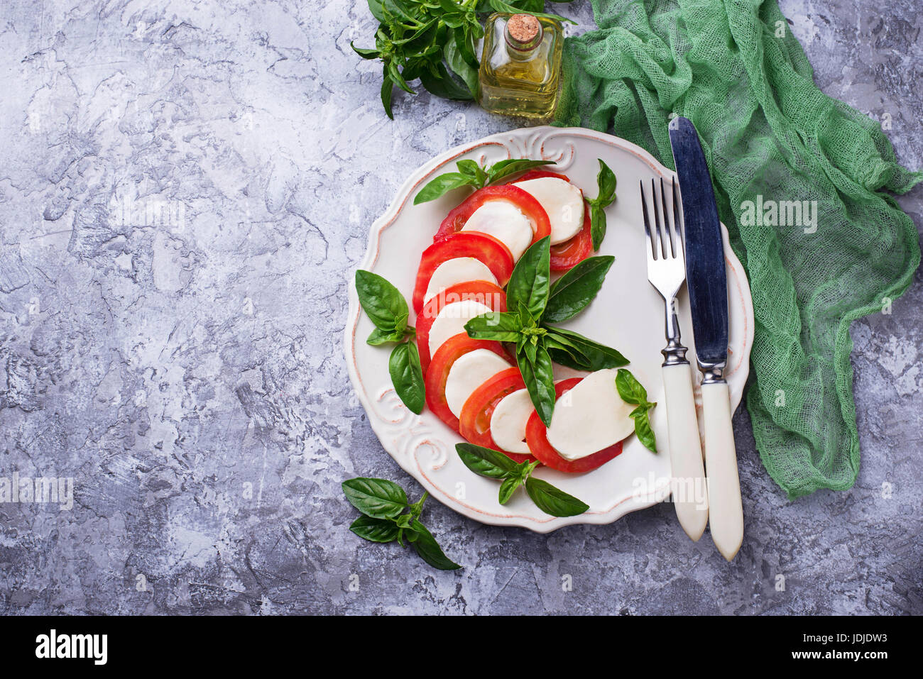 Italian caprese salad with mozzarella, tomatoes and basil. Top view ...