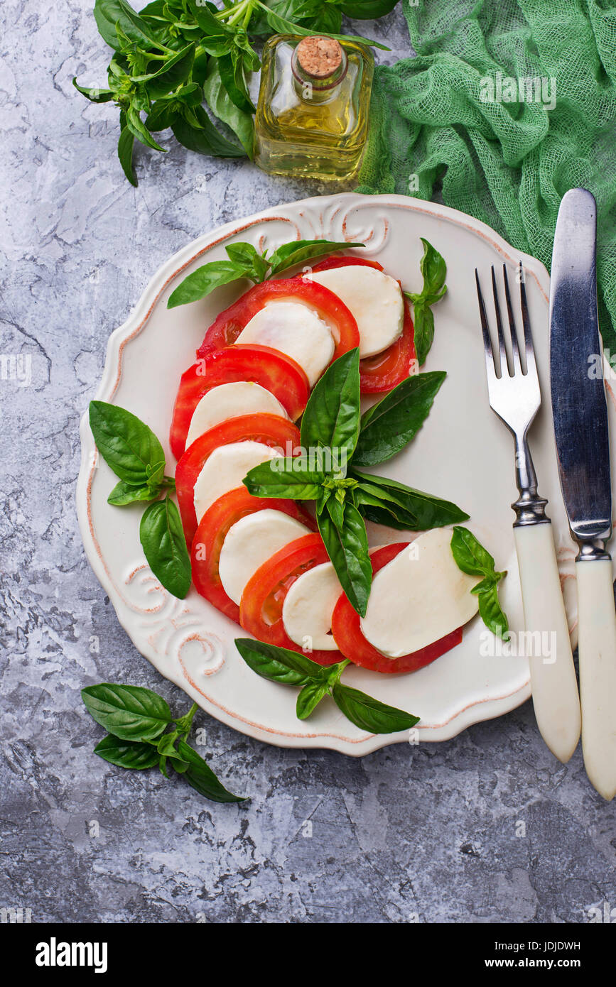 Italian caprese salad with mozzarella, tomatoes and basil. Top view ...