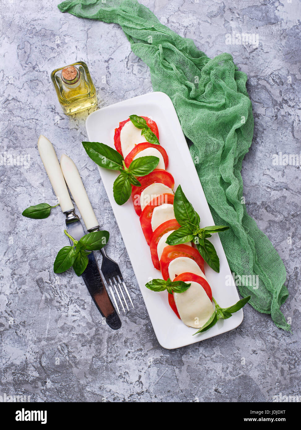 Italian caprese salad with mozzarella, tomatoes and basil. Top view ...