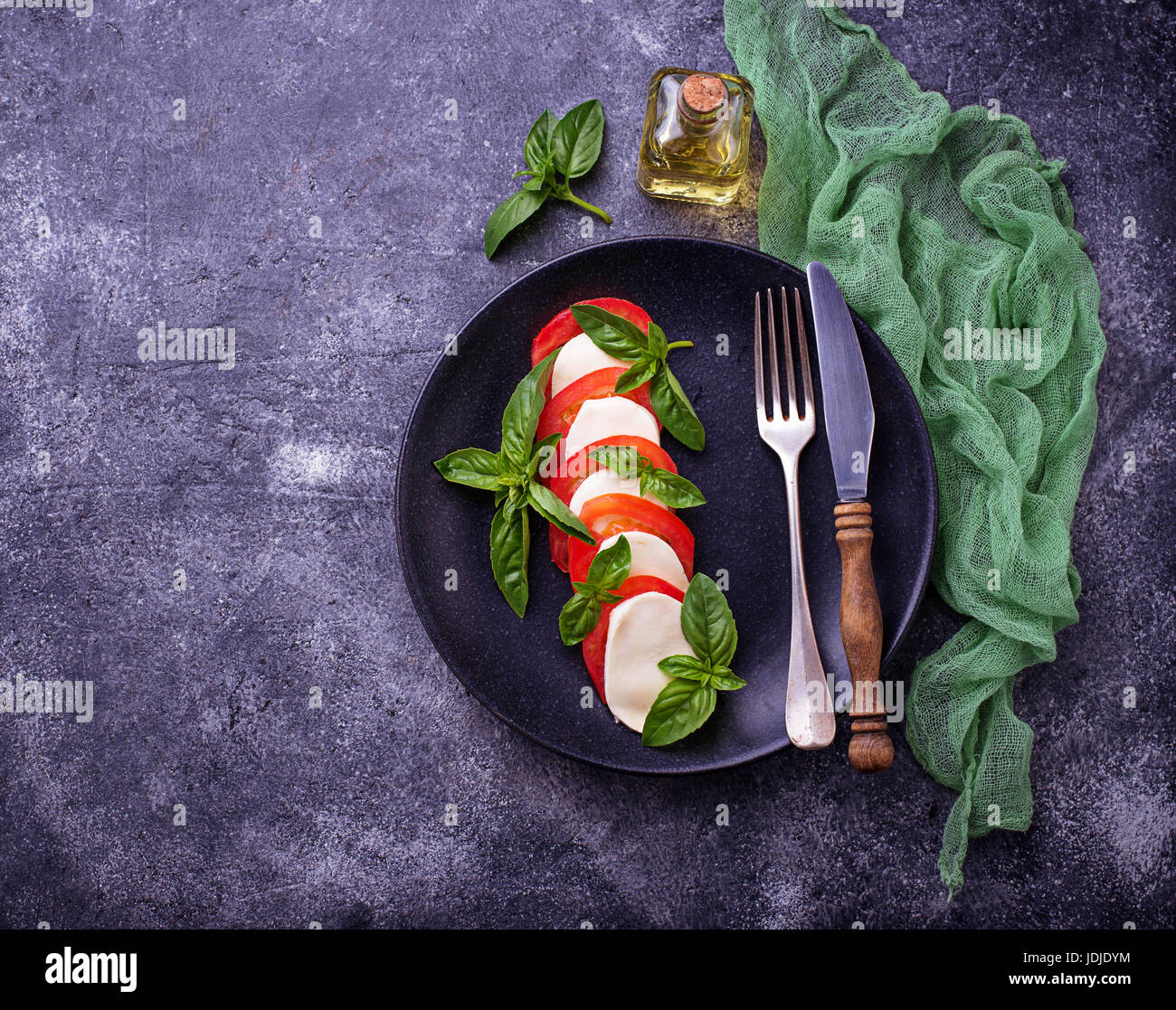 Italian caprese salad with mozzarella, tomatoes and basil. Top view ...
