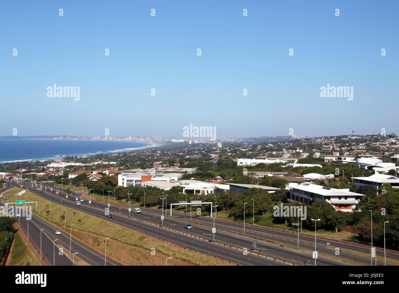 Above view of vehicles on highway heading toward and leaving coastal ...
