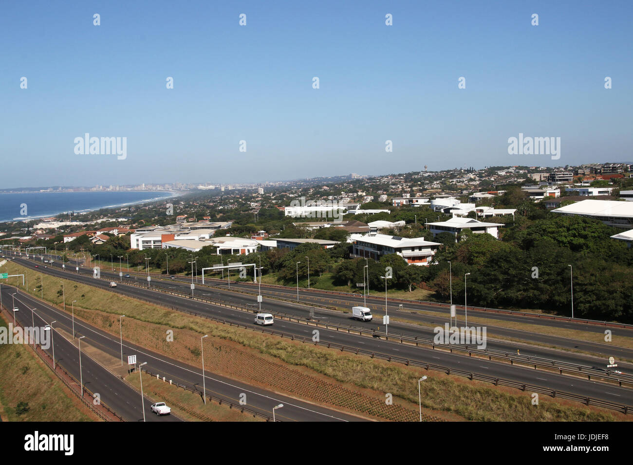 Above view of vehicles on highway heading toward and leaving coastal ...