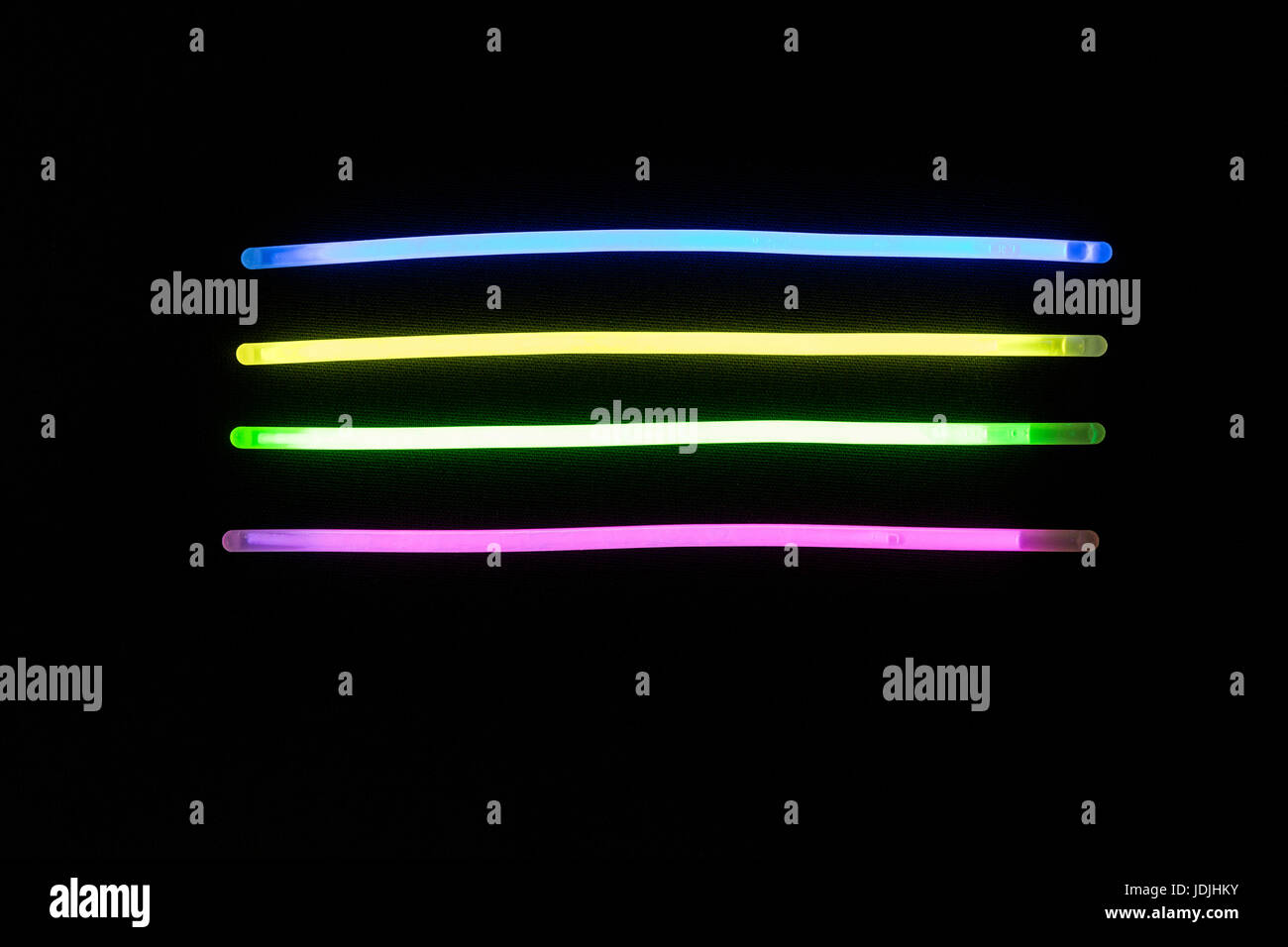 Glow sticks neon light fluorescent on back background. variation of ...