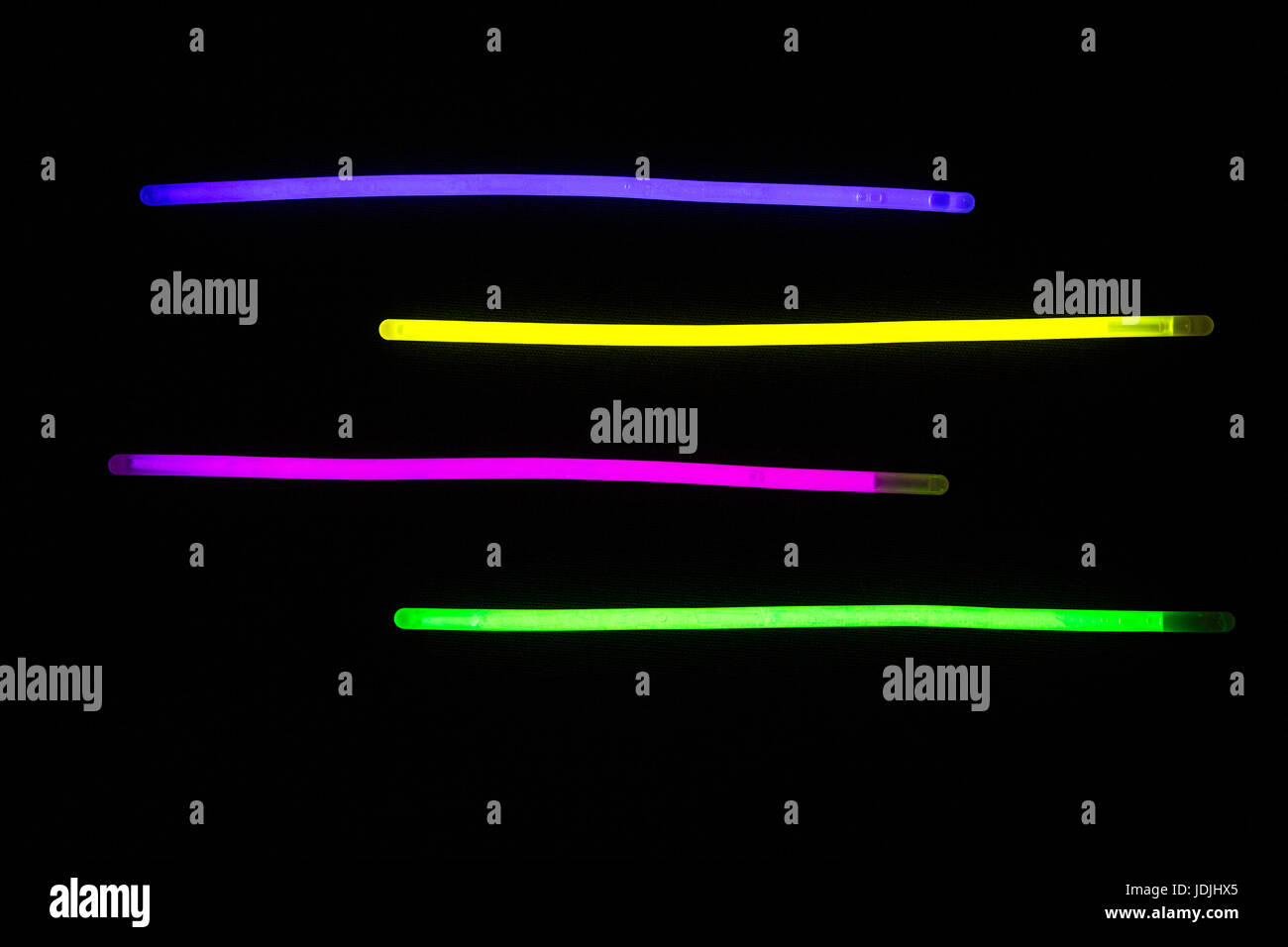 Glow sticks neon light fluorescent on back background. variation of ...