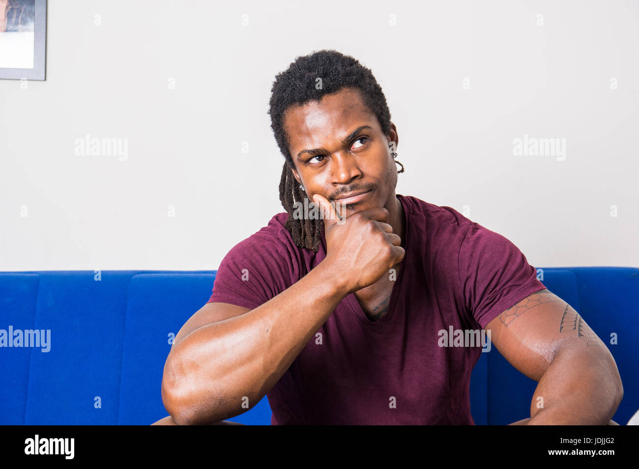 Handsome unsure, doubtful black man thinking, looking up with dubious ...