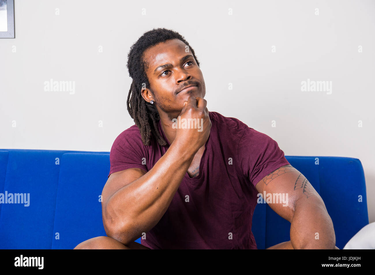 Handsome unsure, doubtful black man thinking, looking up with dubious ...