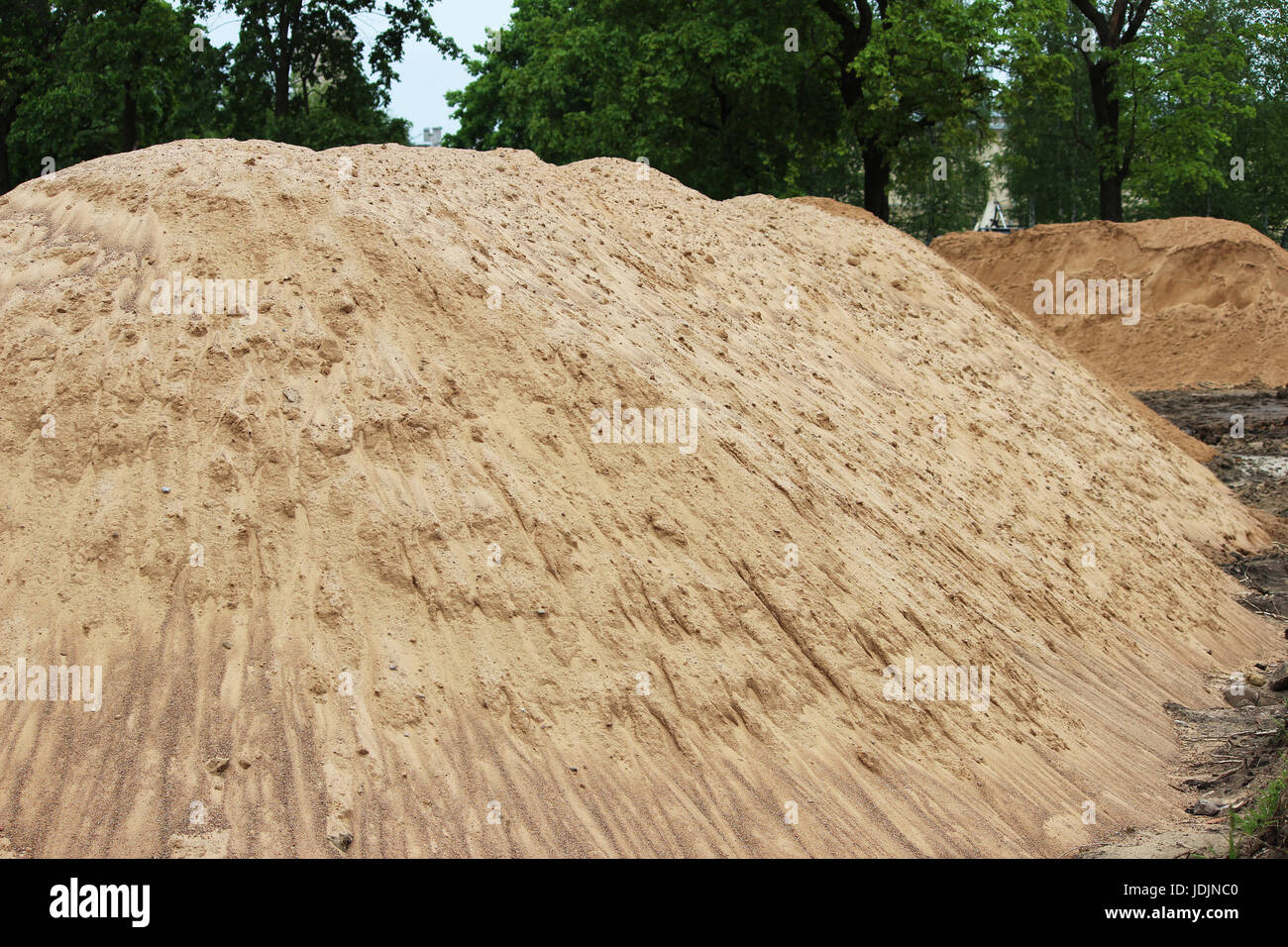 A piles of construction sand on the site for the construction of the ...