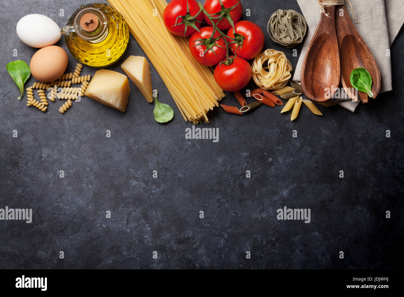 Pasta and ingredients on stone table. Top view with copy space Stock ...