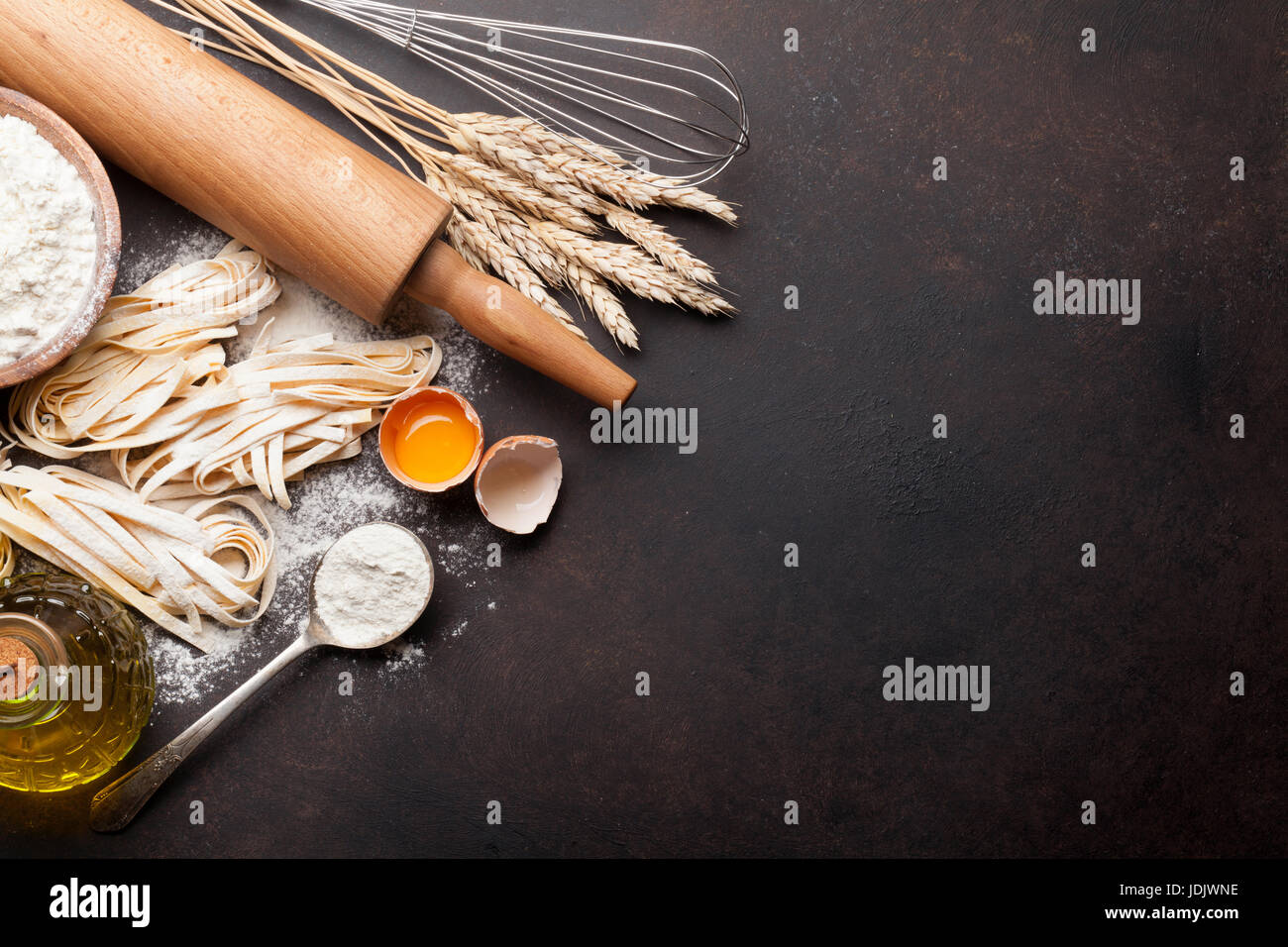Pasta cooking ingredients on wooden kitchen table. Top view with space ...