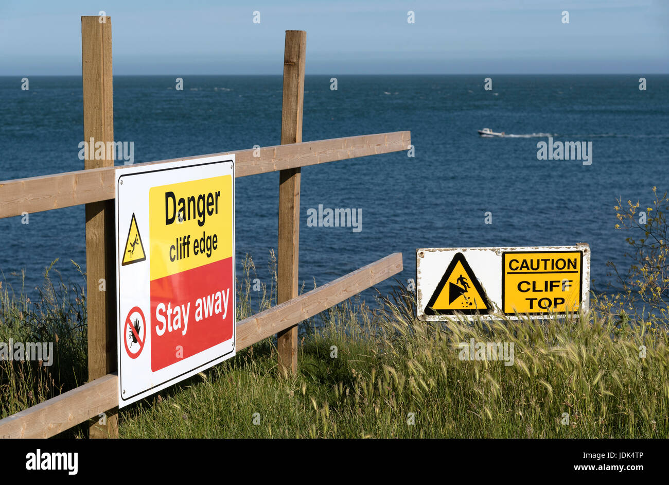 Danger signs on the cliff edge at Peveril Point in Swanage Bay Dorest ...