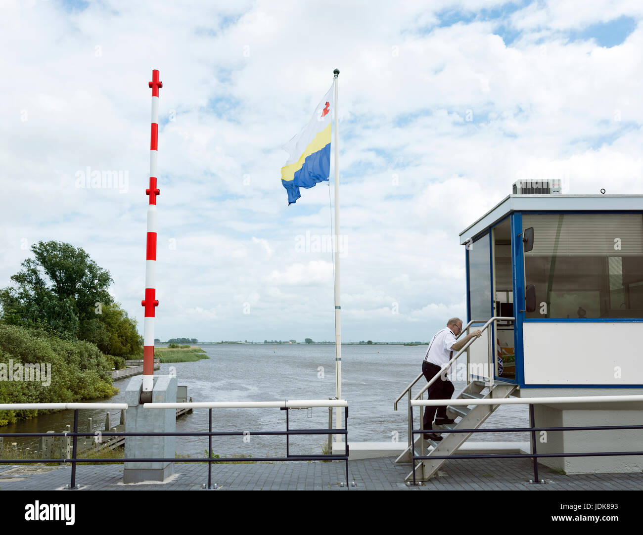 bridgemaster climbs stairs to control cabin on drawbridge in dutch ...