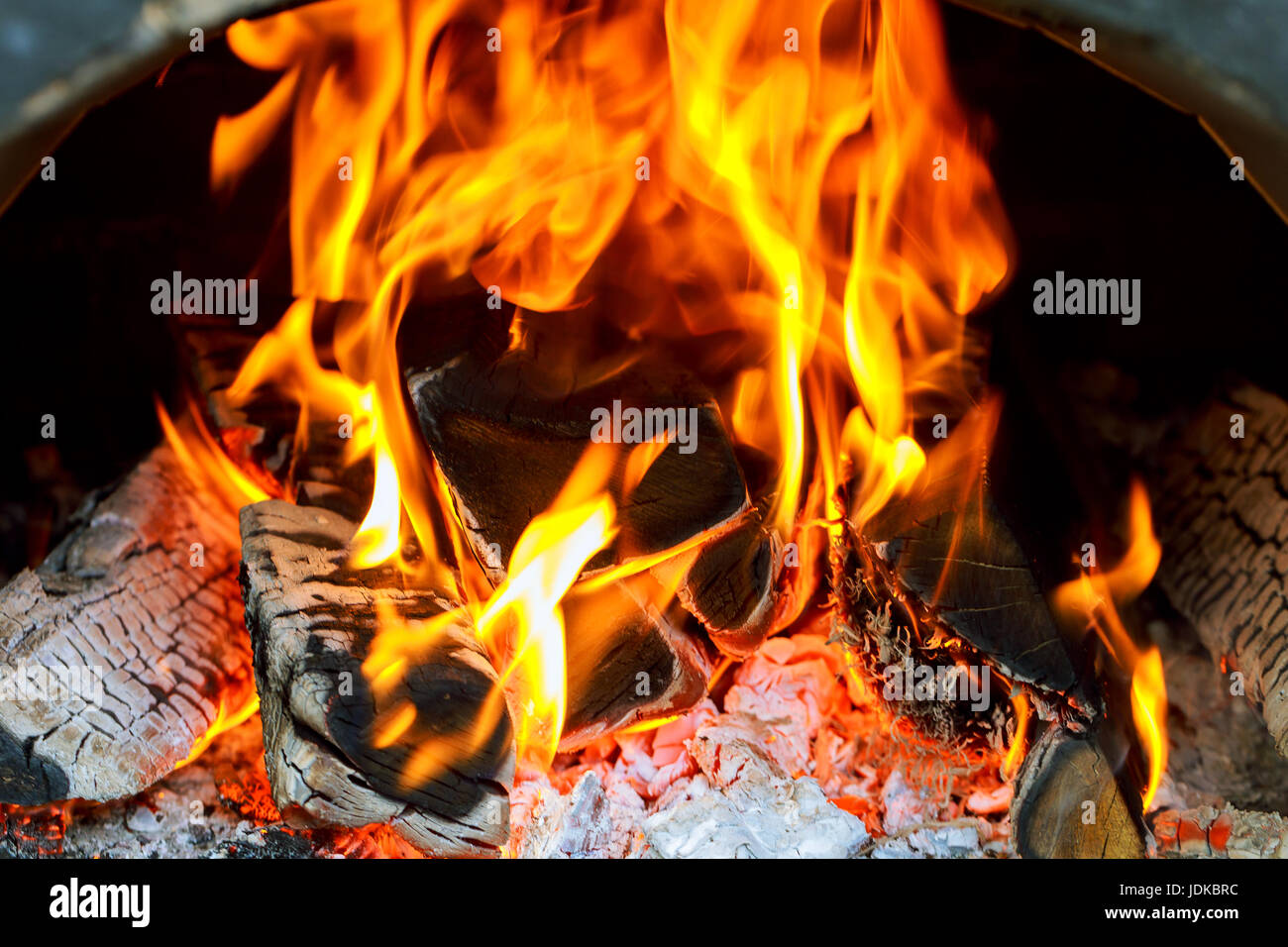 Closeup of firewood burning in Fireplace fire wood Stock Photo - Alamy