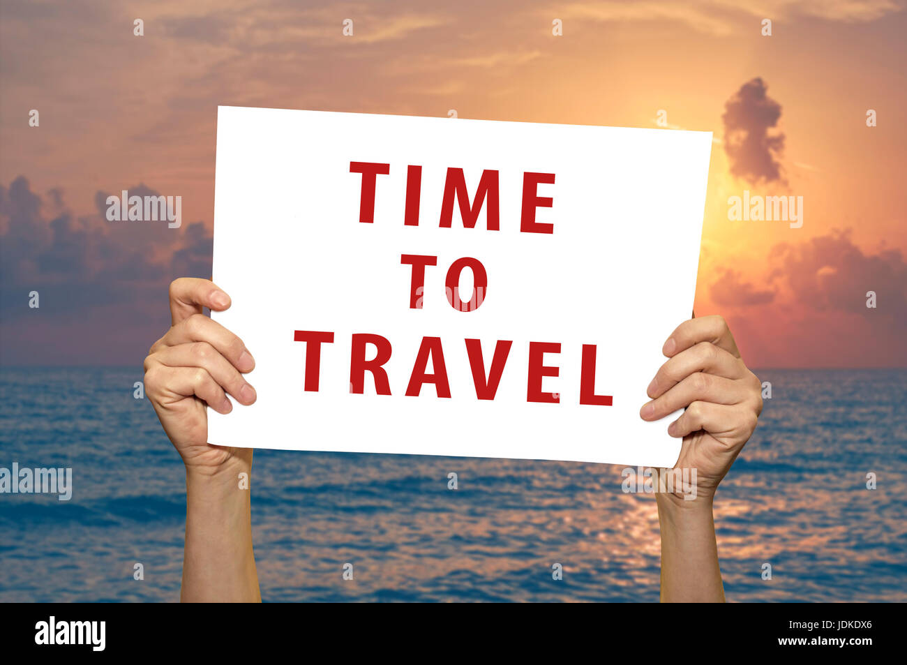 Time To Travel card in hand with a sea on background Stock Photo - Alamy