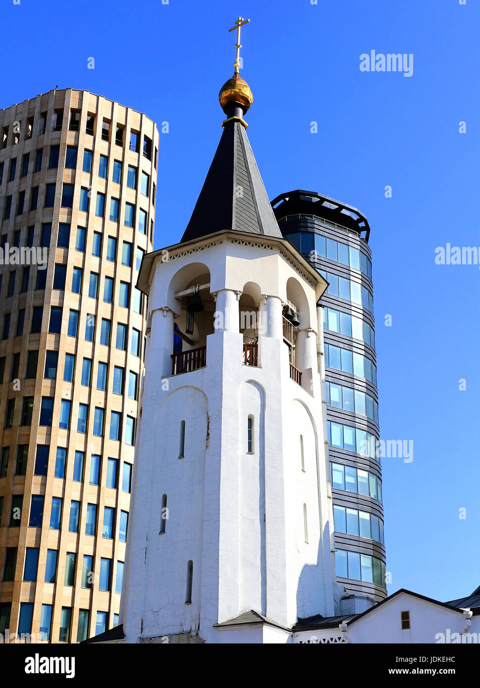 Belfry on the background of modern high-tech buildings Stock Photo - Alamy