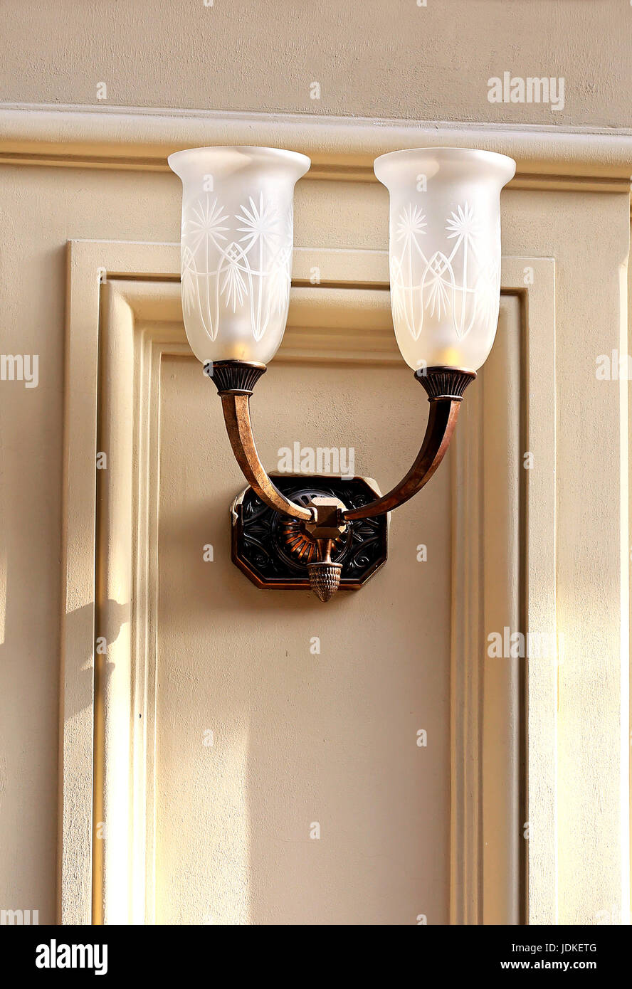 Electric lighting of the two lamps on the wall of a light coffee color ...