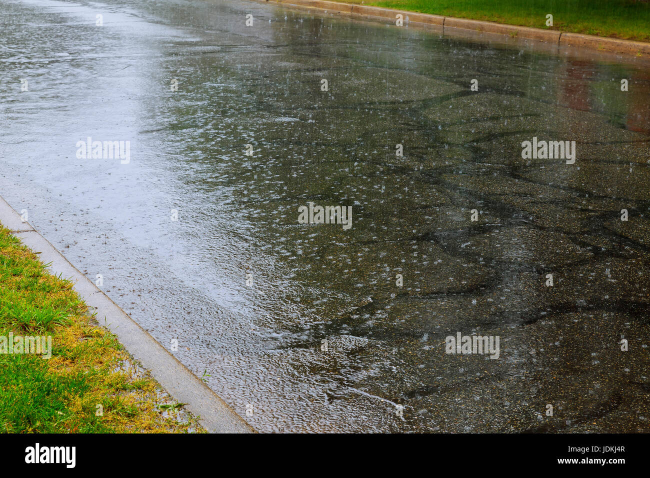 View from ground of traffic on wet road, highway with mist splash after ...