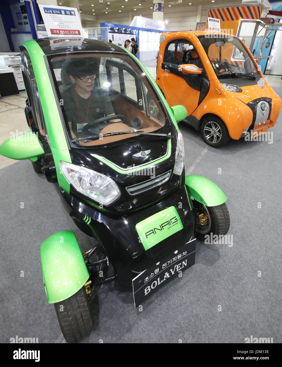 Super-mini electric car A visitor looks at a one-man electric vehicle ...