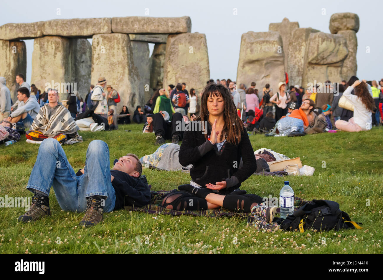 Summer Solstice celebrations at Stonehenge. People meditate at sunrise ...
