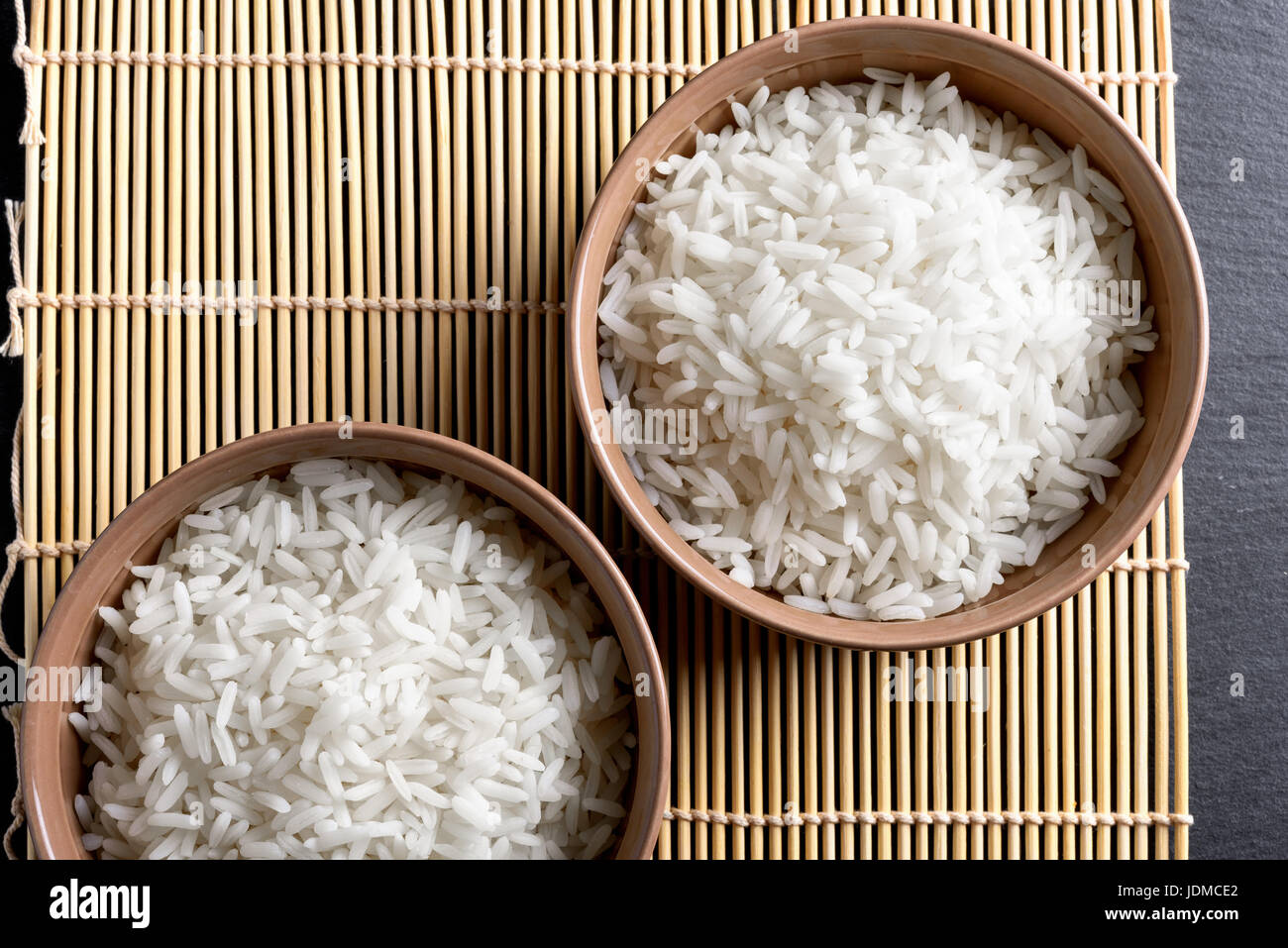 Top view: steamed cooked white basmati rice in round ceramic bowls over ...