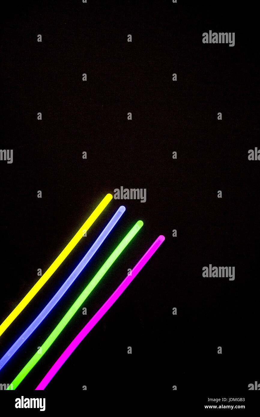 Glow sticks neon light fluorescent on back background. variation of ...
