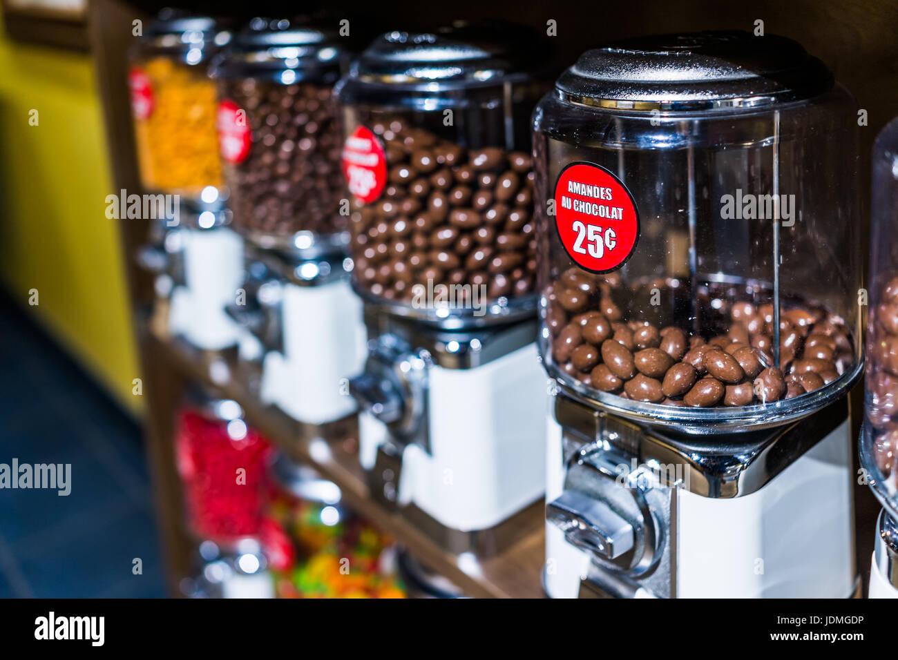 Chocolate covered almonds in French coin dispenser candy machines Stock ...