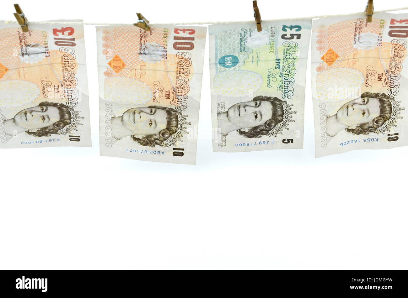 Dirty money hanging from a clothesline isolated on white Stock Photo ...